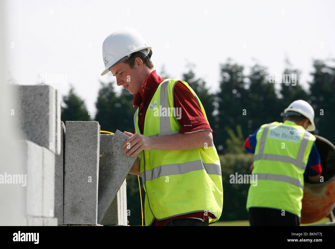 Building apprentices on a building site Stock Photo - Alamy