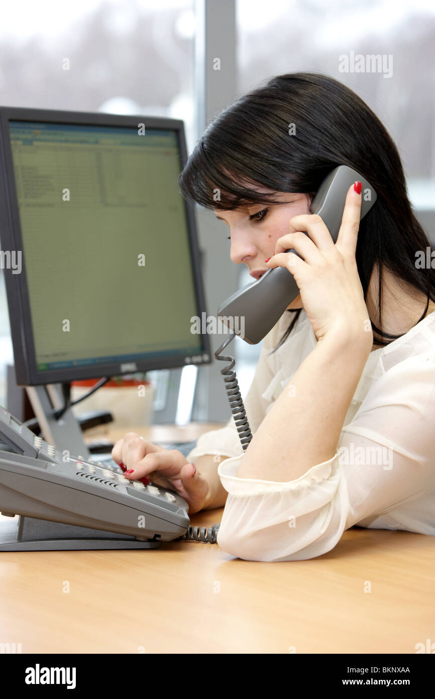 Young Woman Office Administrator Working In An Office Making Or ...