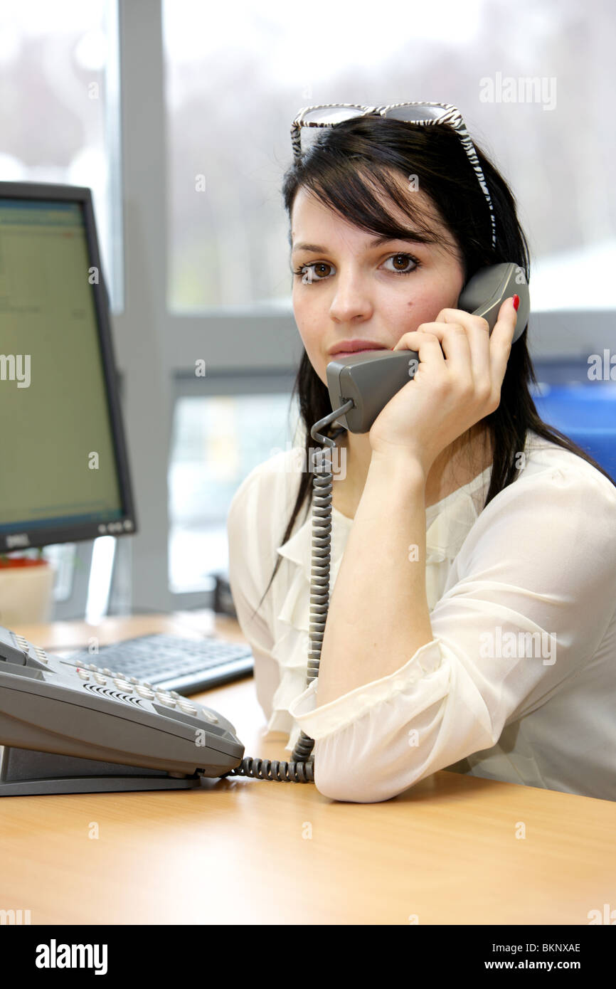 Young Woman Office Administrator Working In An Office Making Or ...