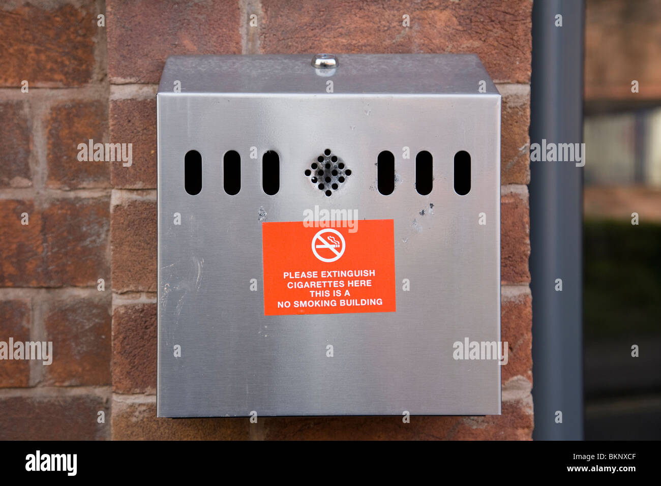 Cigarette waste bin outside an office front entrance Stock Photo - Alamy