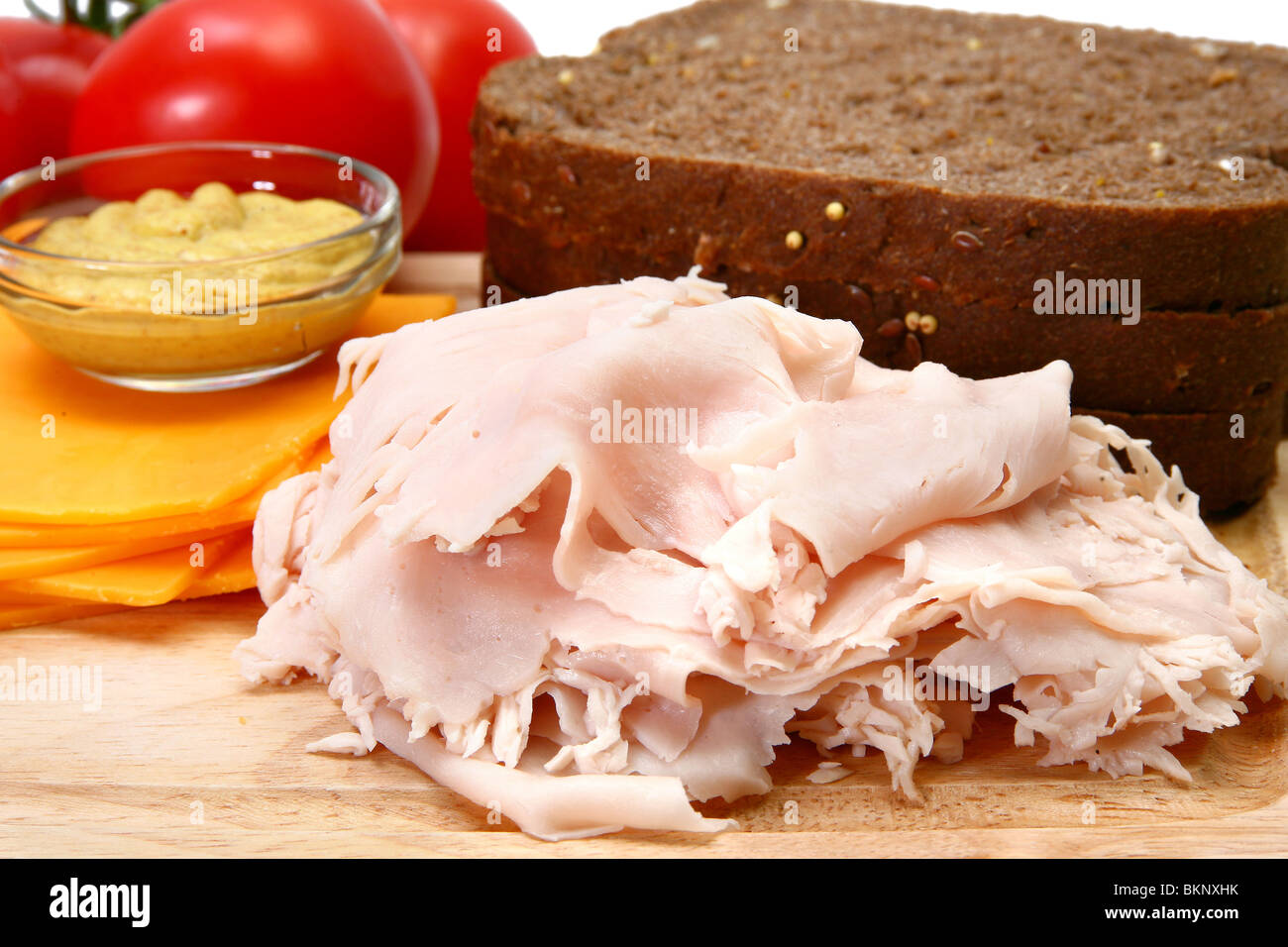 Makings of a turkey sandwich including dark German wheat, sliced turkey ...