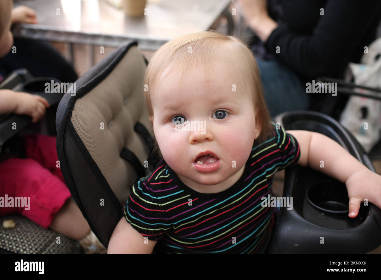 Child with face in stroller Stock Photo - Alamy