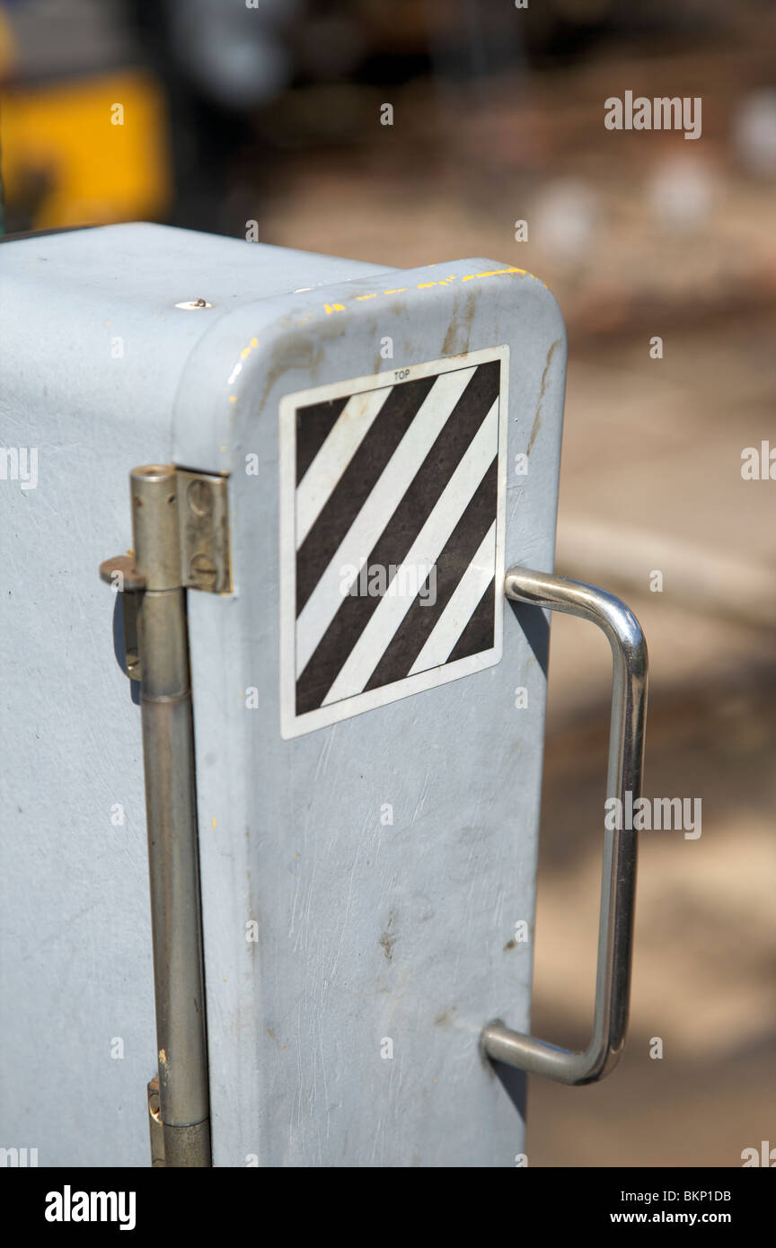 A railway side line grey telephone box with black and white hatched ...