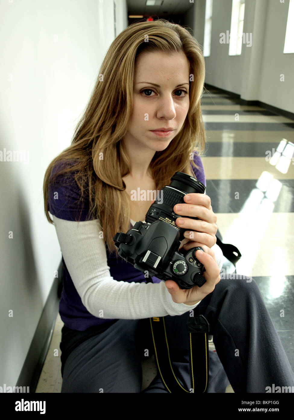 female woman photographer taking photographs pictures using a black SLR ...
