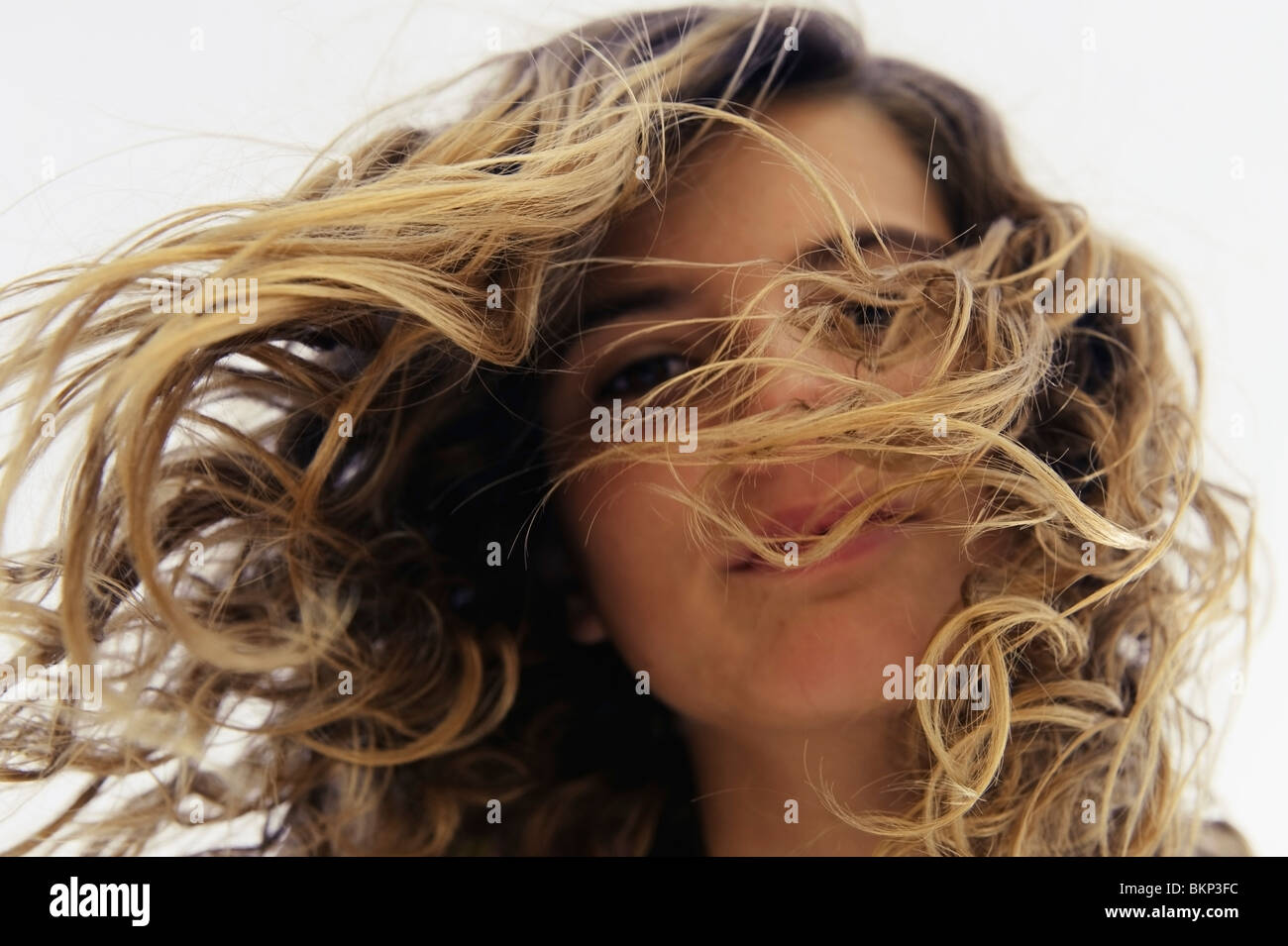 Young Woman With Long Hair Blowing In The Wind Stock Photo - Alamy