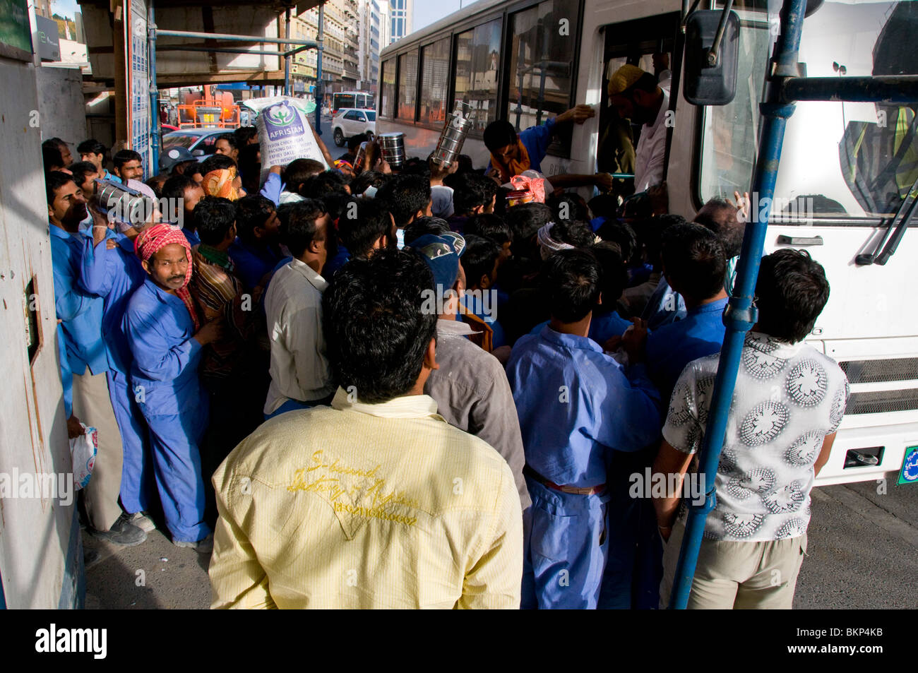 Foreign workers taking bus Dubai Stock Photo - Alamy