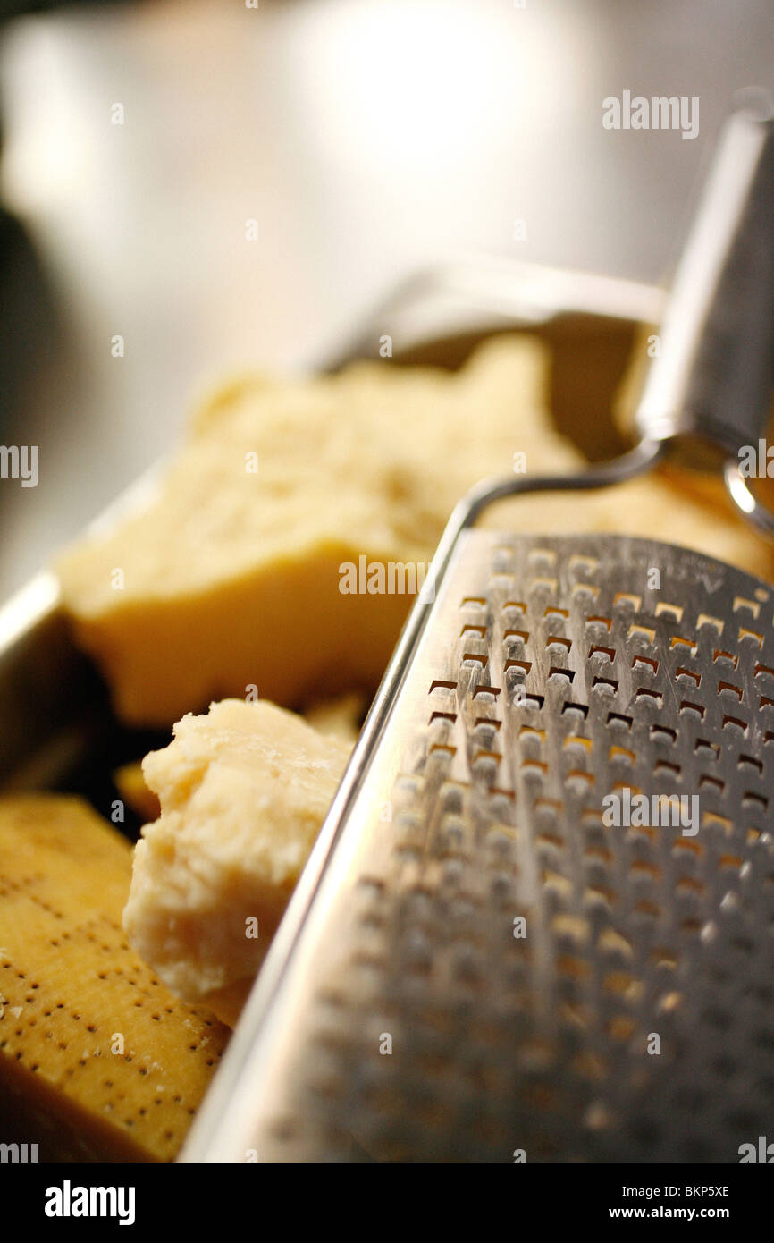 Food prep - Parmesan cheese & grater in a restaurant kitchen Stock ...