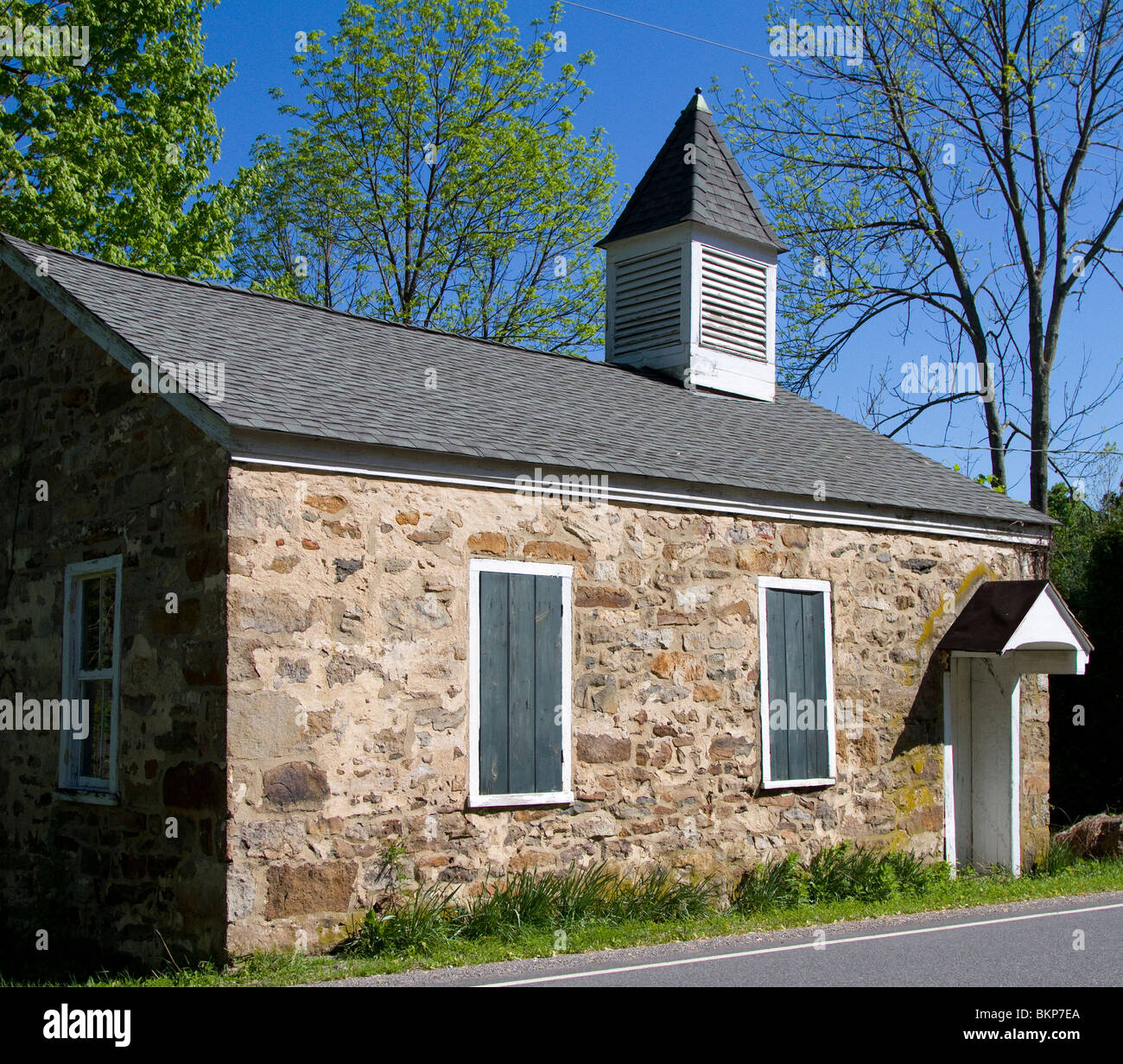 A roadside vintage stone one room schoolhouse with cupola Stock Photo ...