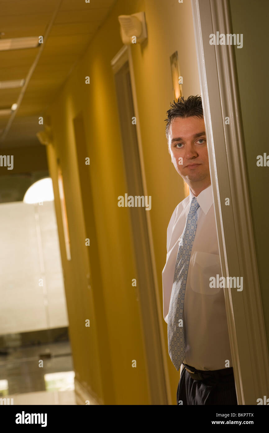 Businessman office leaning door frame hi-res stock photography and ...