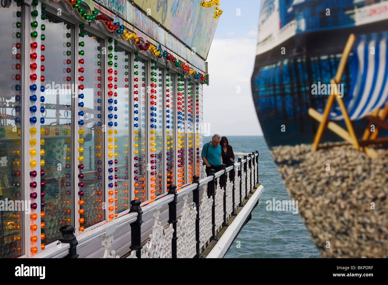 Brighton visitors and pier amusement arcade lights and canvass beach ...
