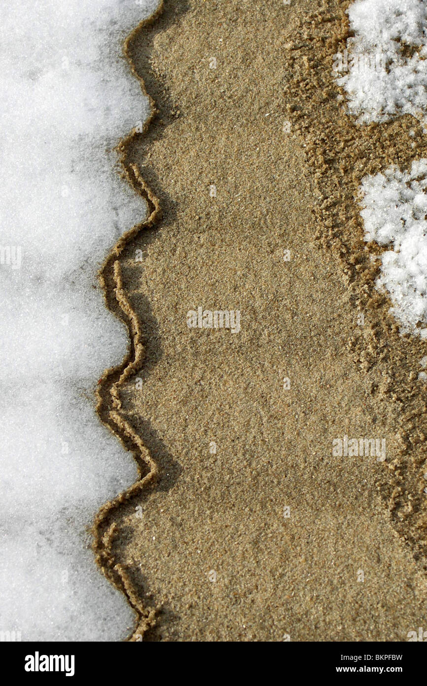 Pattern formed by melting grains of hail on the sand Stock Photo - Alamy