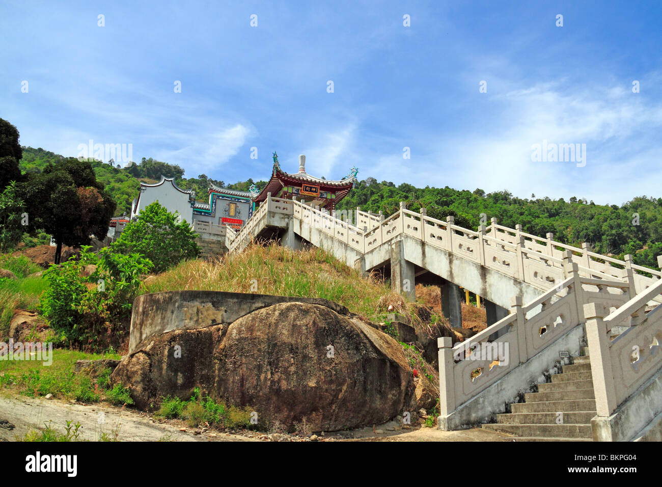 An image of a staircase going up to an ancient Chinese temple on a hill ...