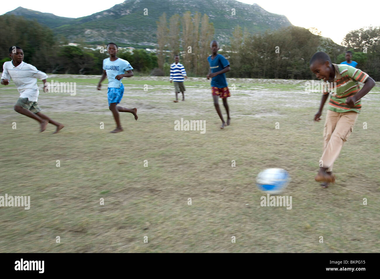 Barefoot kids playing football hi-res stock photography and images - Alamy