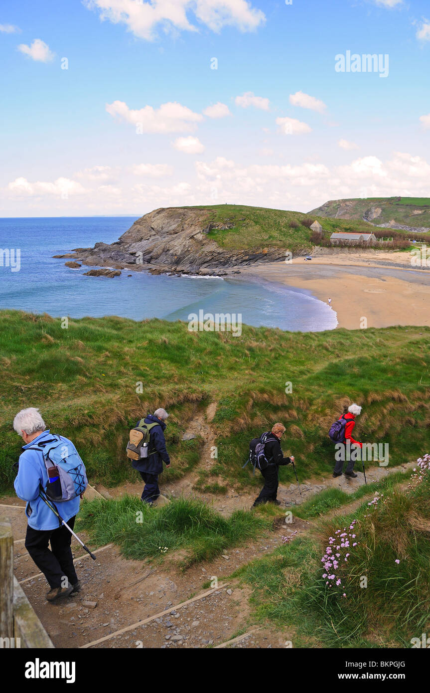 walkers on the south west coast path at gunwalloe church cove near ...
