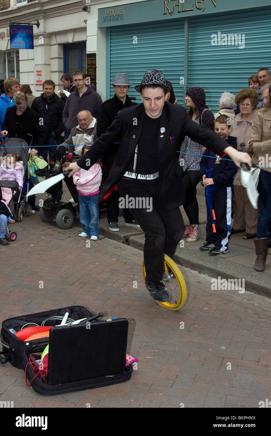 street magician artist on monocycle children black Stock Photo - Alamy