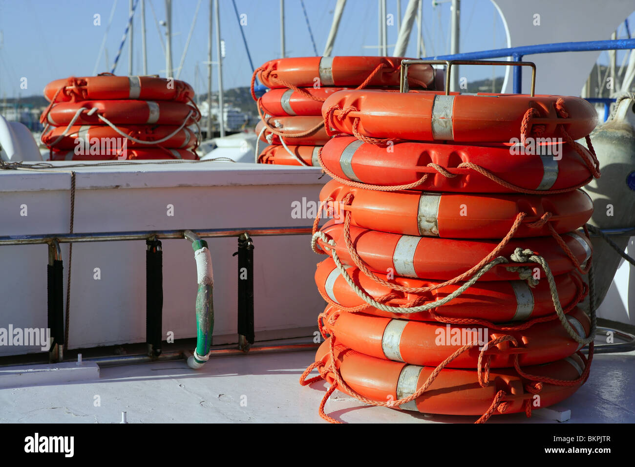Stacked orange rescue round buoy, sea marine lifesaver Stock Photo - Alamy