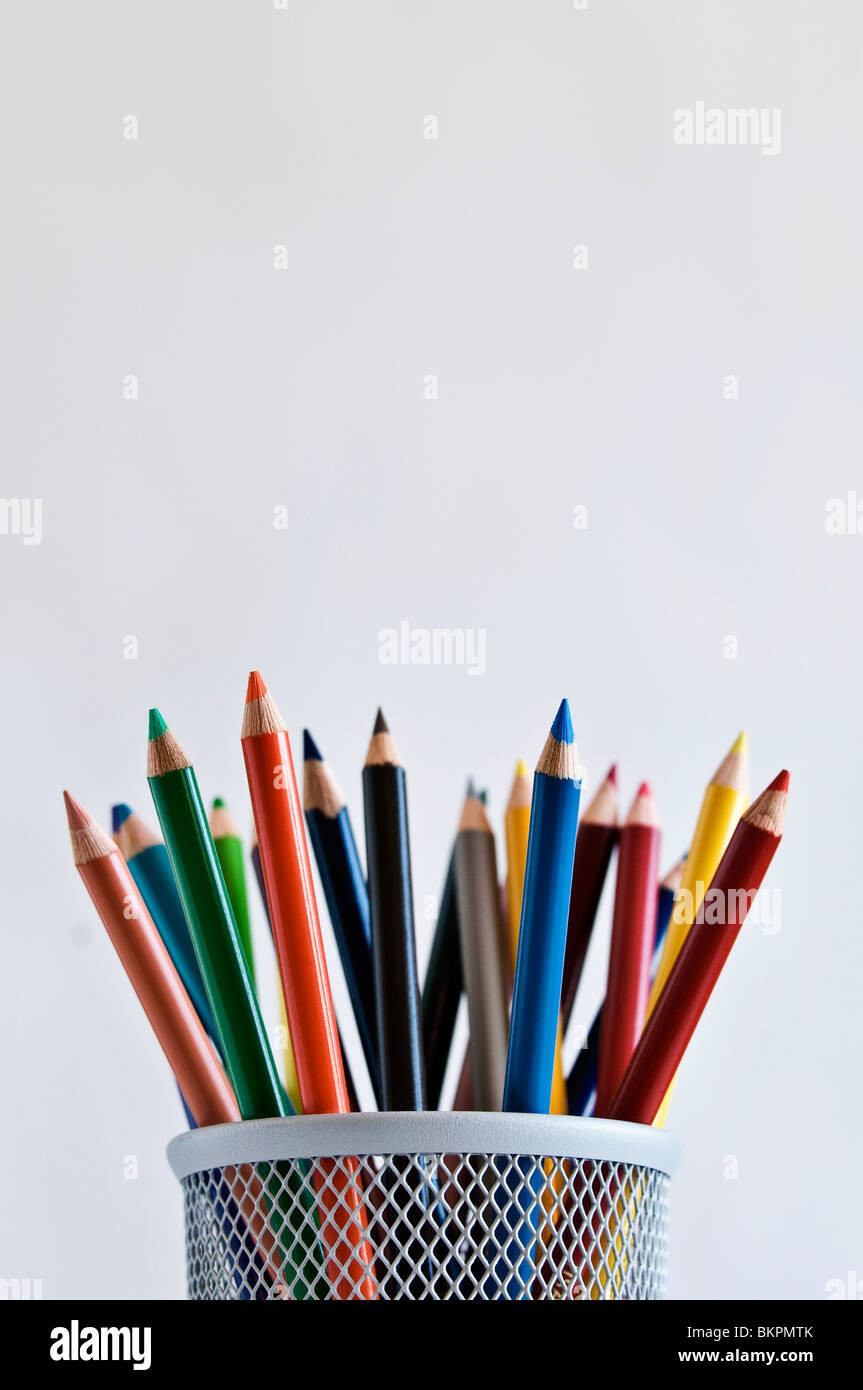 Colored art pencils in pencil holder, on white background Stock Photo ...