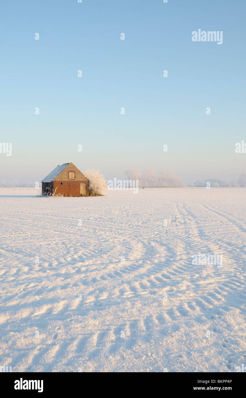 landscape with snow covered field and small shed Stock Photo - Alamy