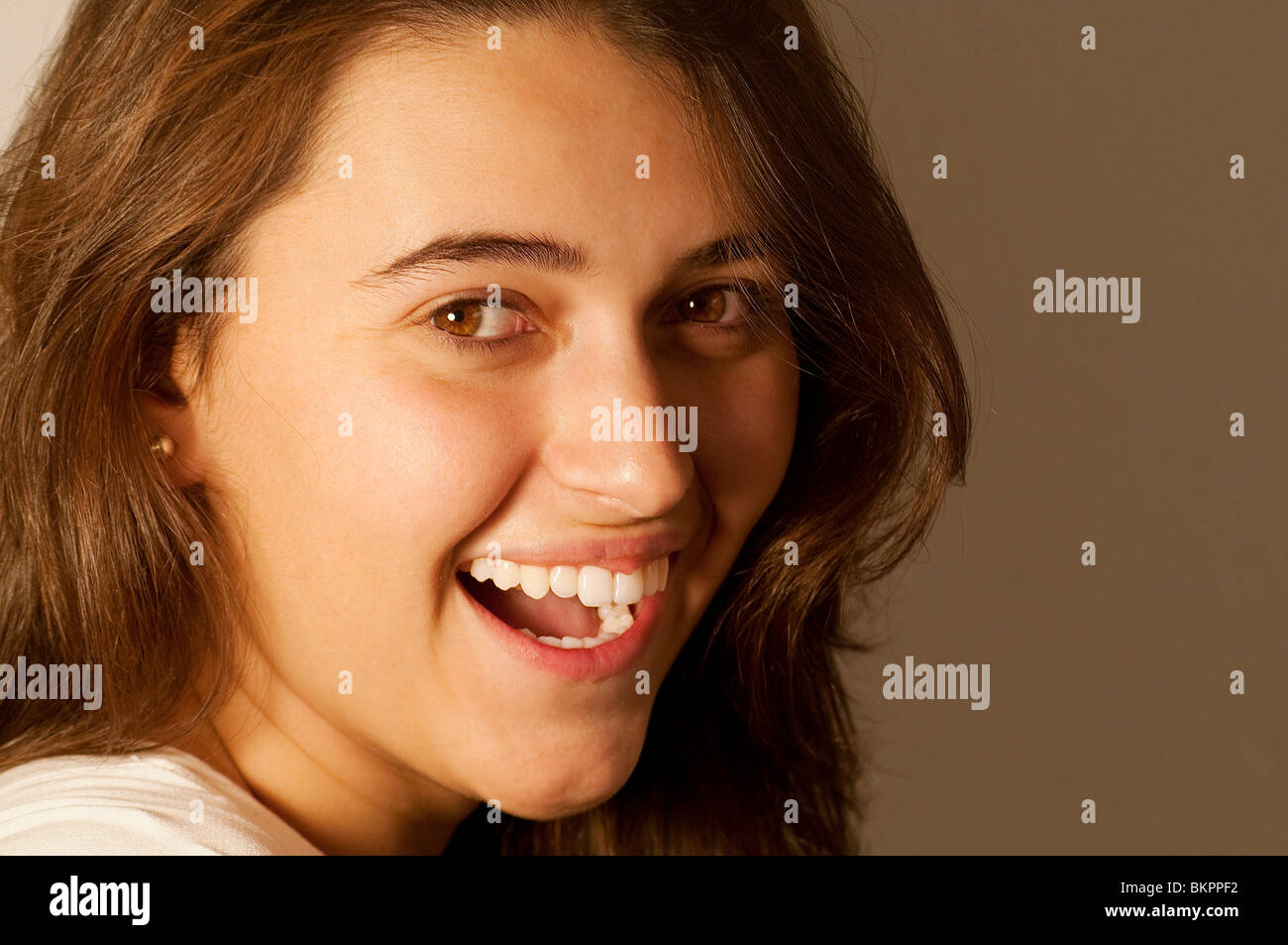 Young woman laughing and looking at the camera. Close view Stock Photo ...
