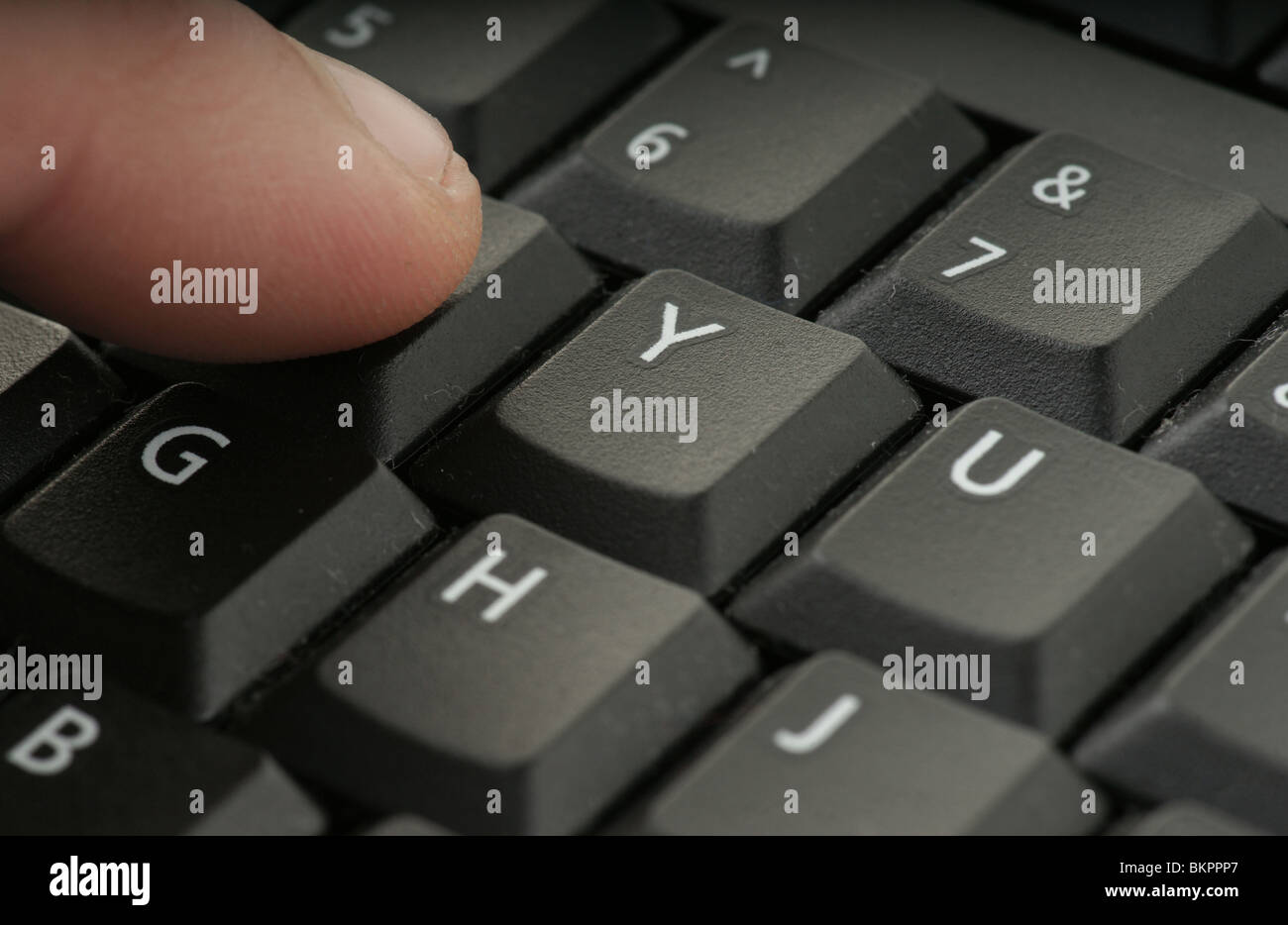 great image of a finger on computer keyboard Stock Photo - Alamy