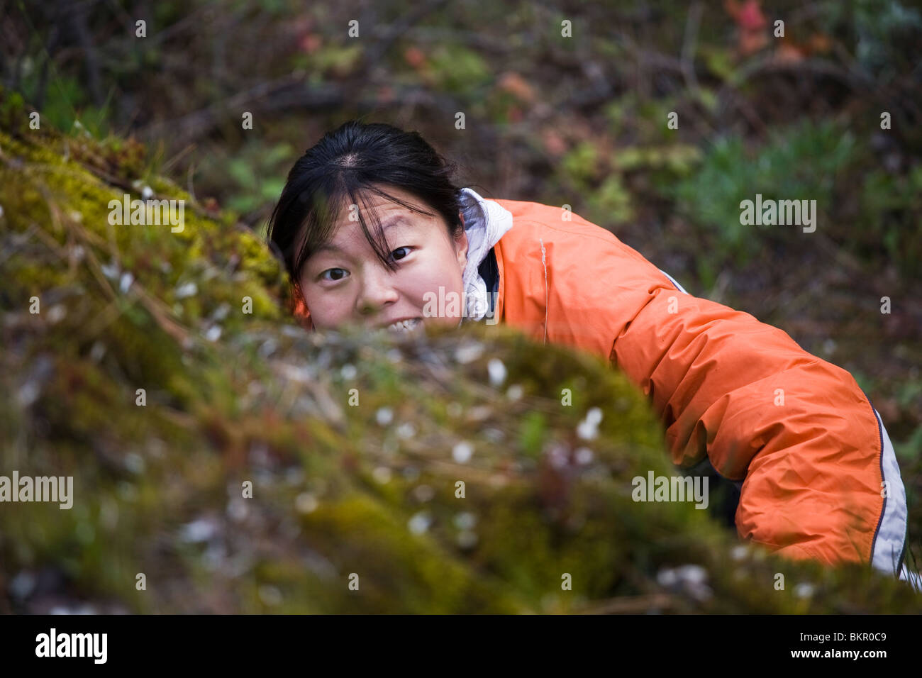 Asian woman hiding in green forested area Stock Photo - Alamy