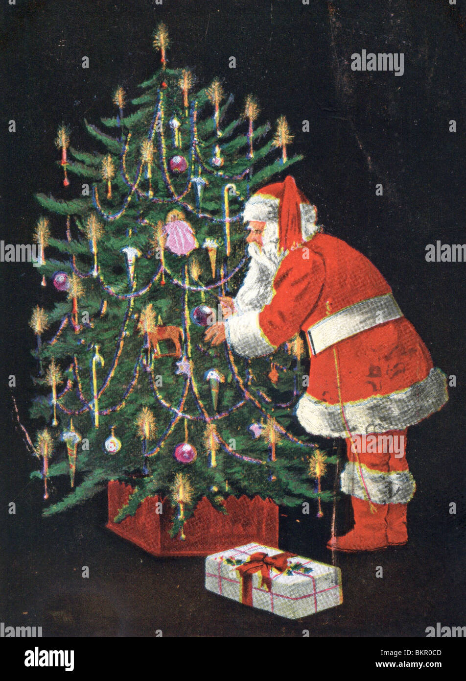 Father Christmas Decorating the Christmas Tree Stock Photo - Alamy