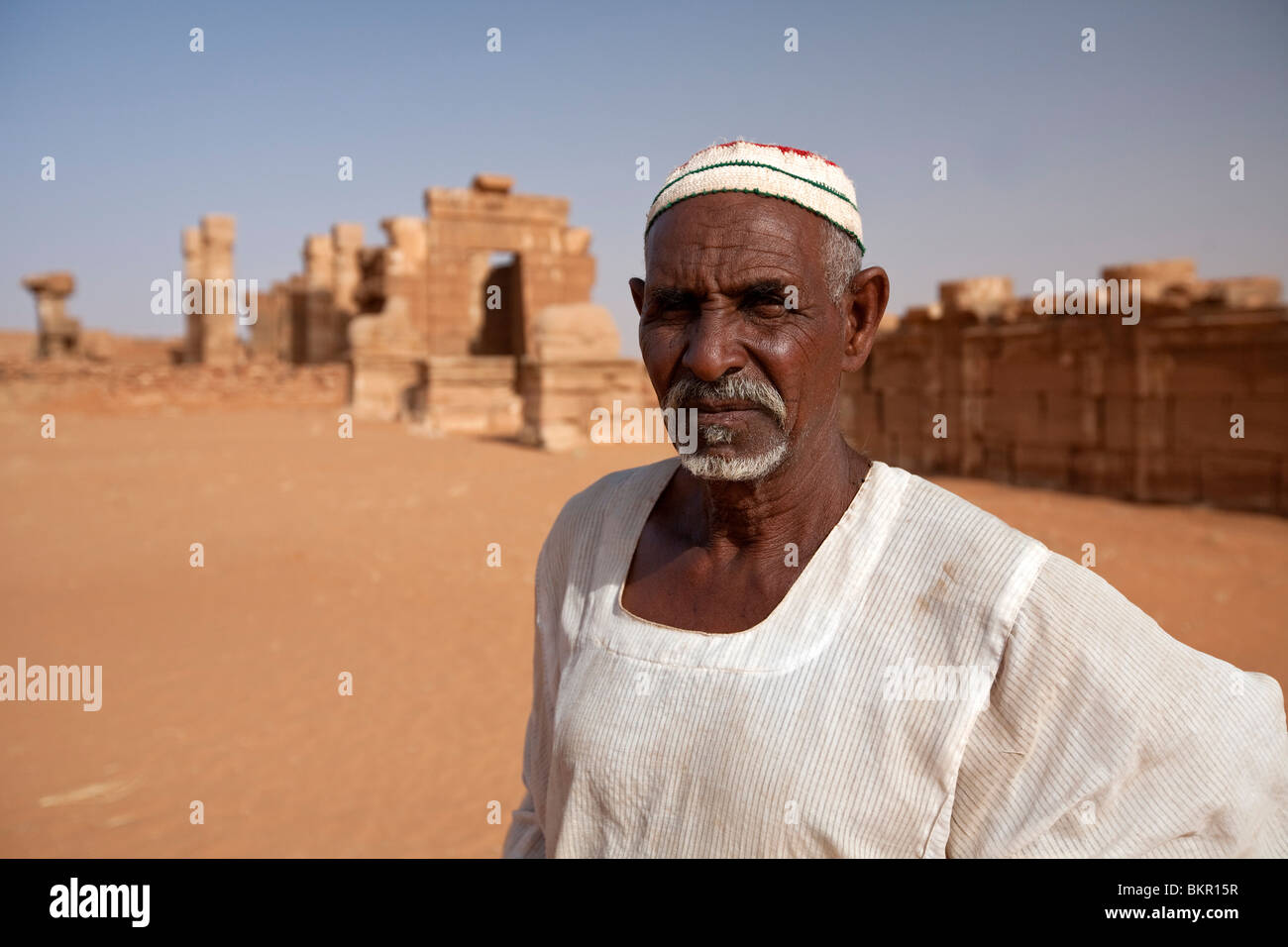 Sudan, Nagaa. The solitary guide at the remote ruins of Nagaa stands in ...