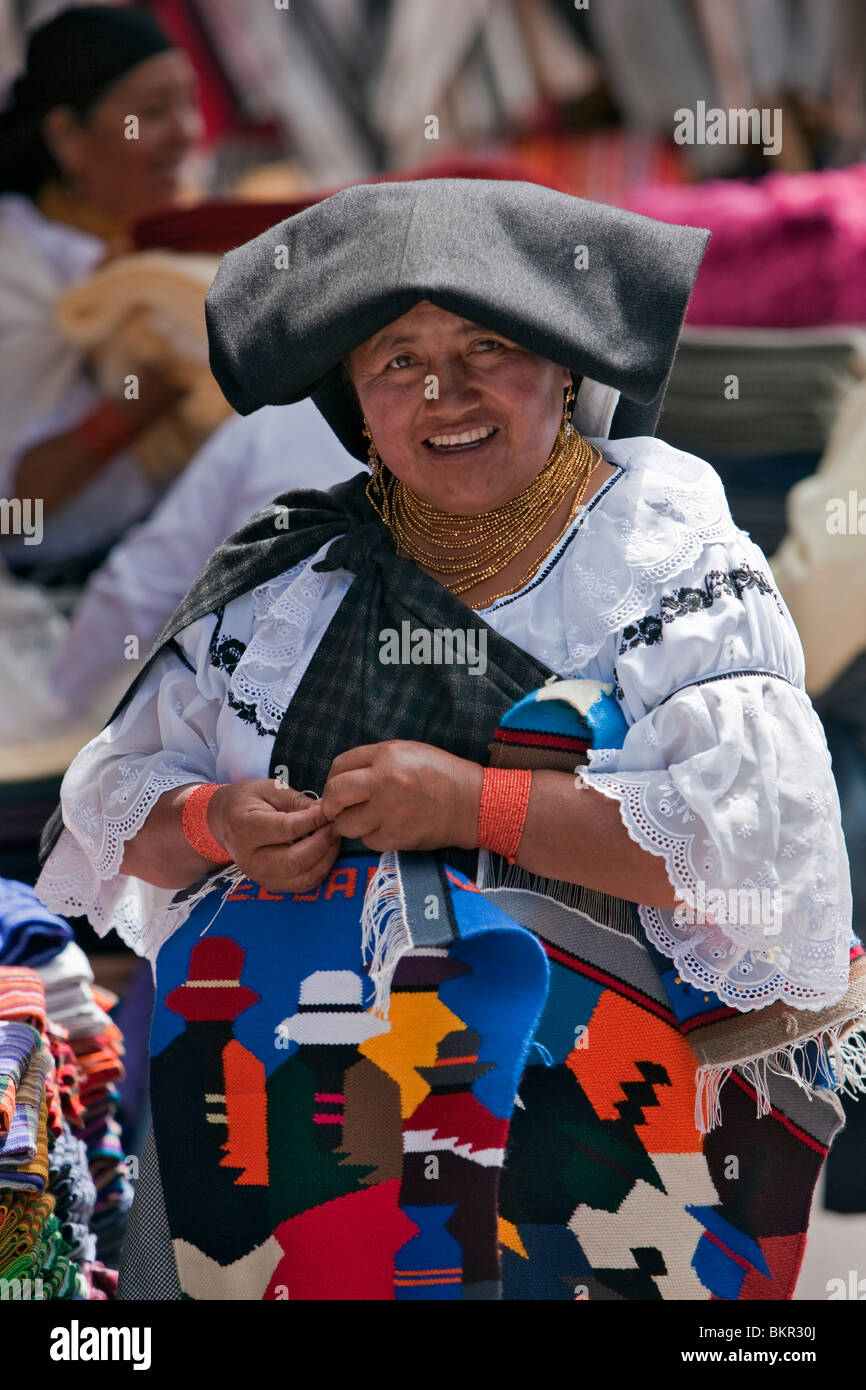 Ecuador, An indigenous Ecuadorian woman puts the final touches on her ...