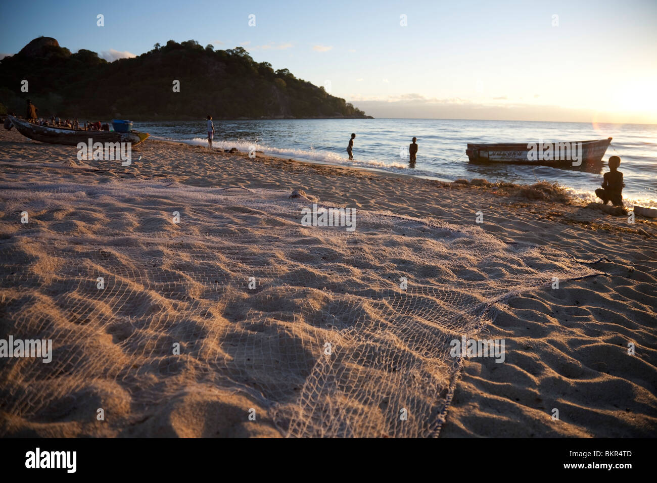 Malawi, Monkey Bay. Nets dry on the beach as dawn breaks over Lake ...