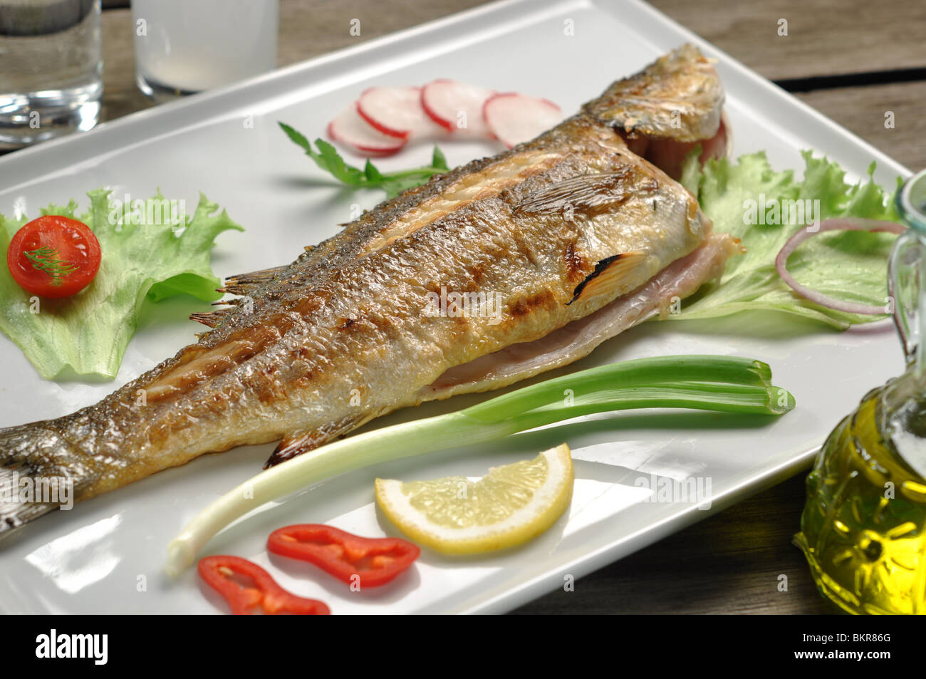 grilled sea bass on the plate Stock Photo - Alamy
