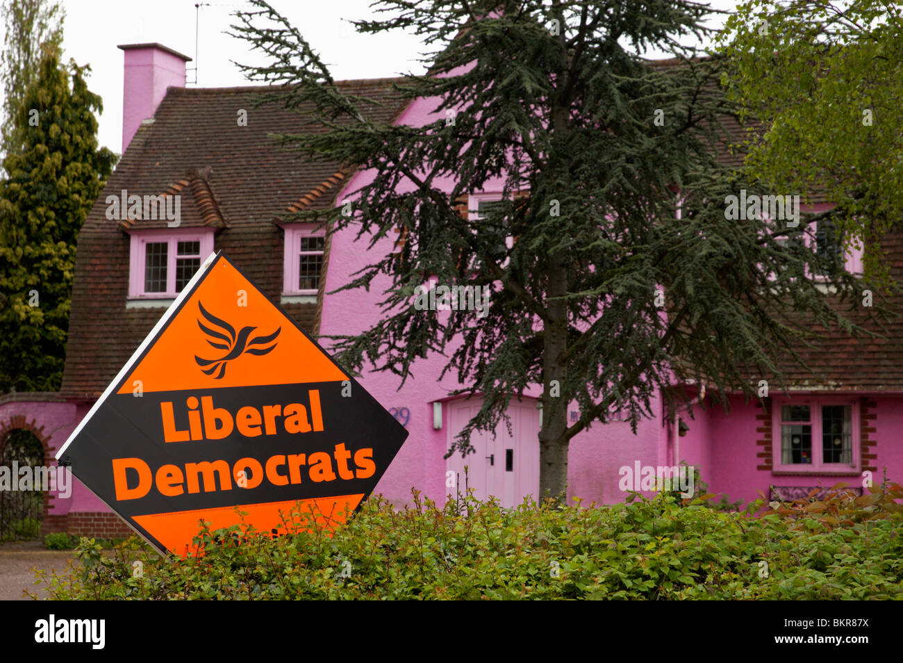 Liberal Democrat Party poster displayed on a private hedge outside a ...