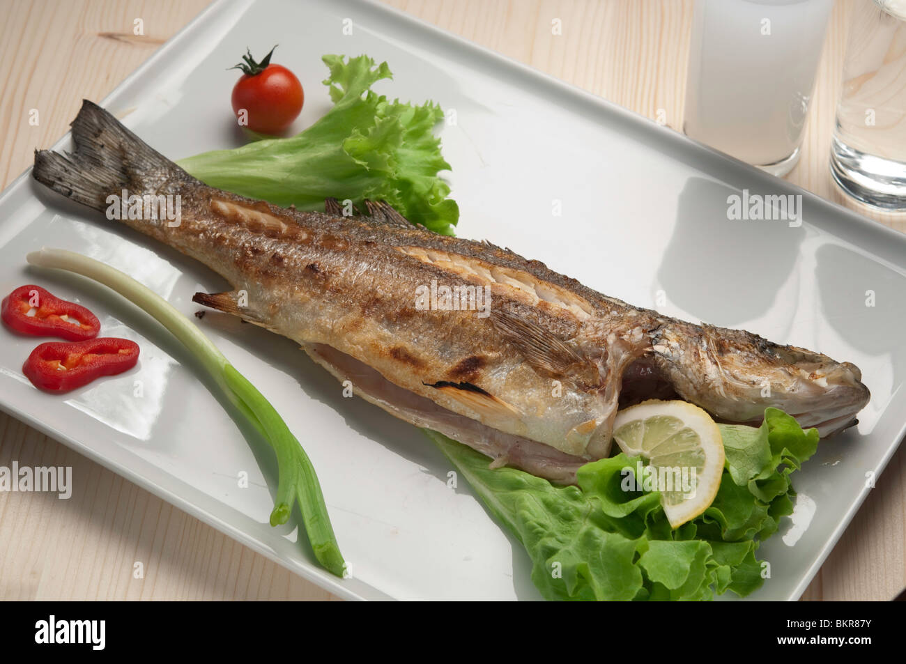 grilled sea bass on the plate Stock Photo - Alamy