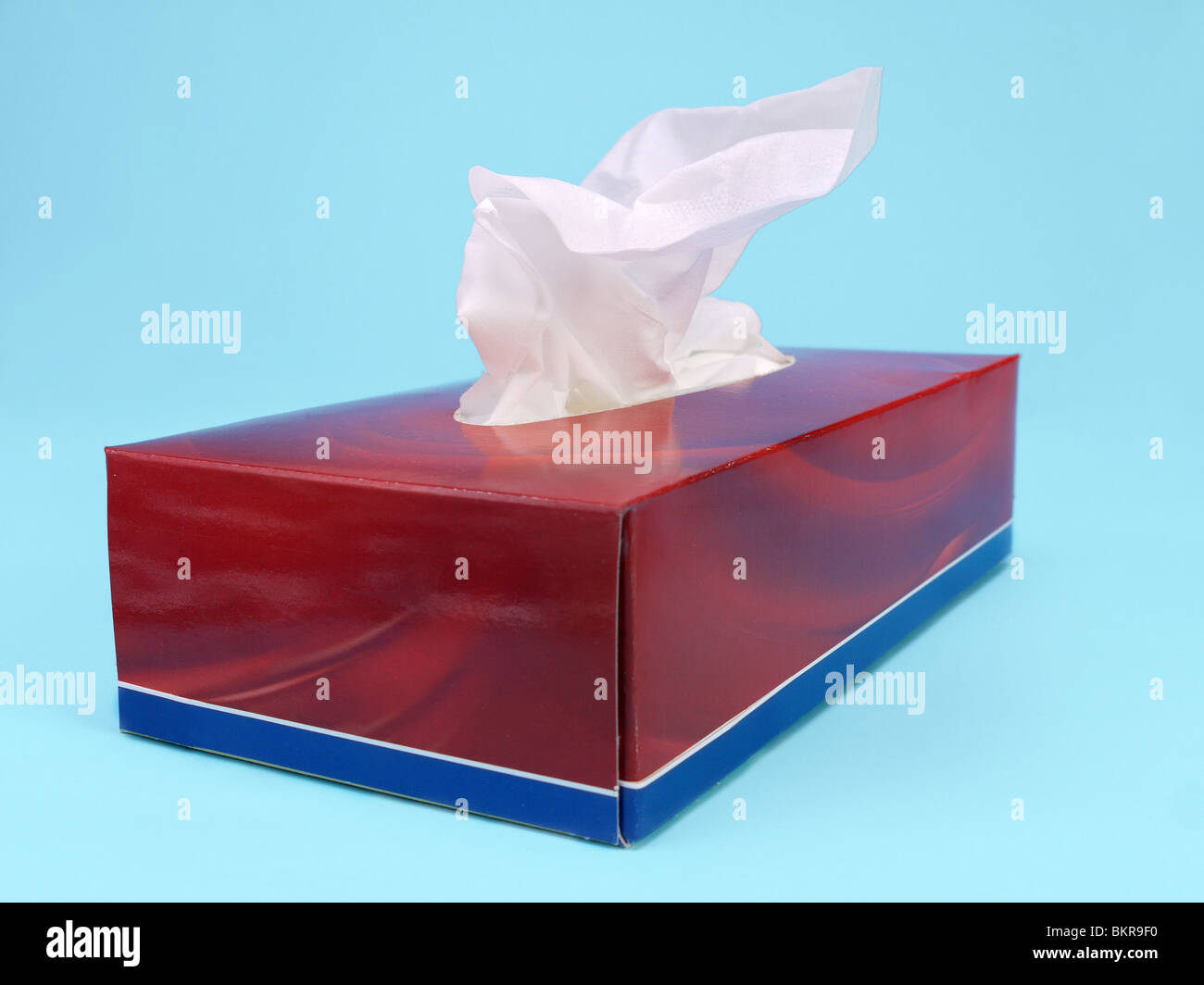 Paper tissue box over light blue background Stock Photo - Alamy