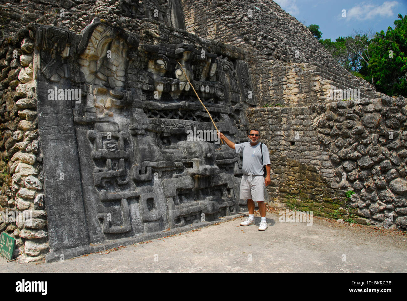 Guide explaining relief in Caracol ruins, Mayan Mountains, Cayo ...