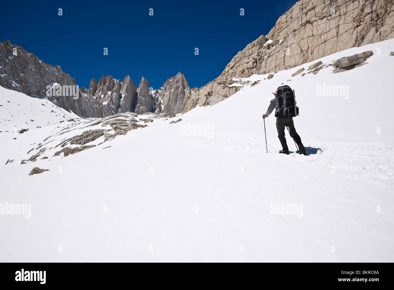 Adult hiker crosses snow on mountaineers route to Mount Whitney, Sierra ...