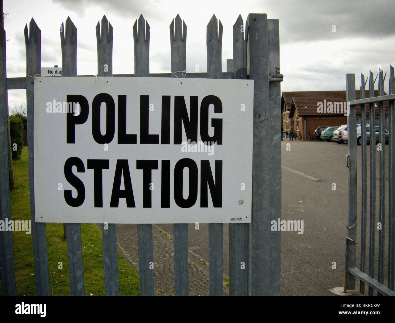 Polling station sign attached to metal security gates outside a UK ...