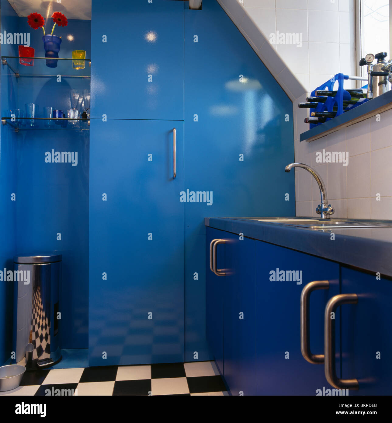 Bright blue fitted storage cupboard in modern blue kitchen Stock Photo ...