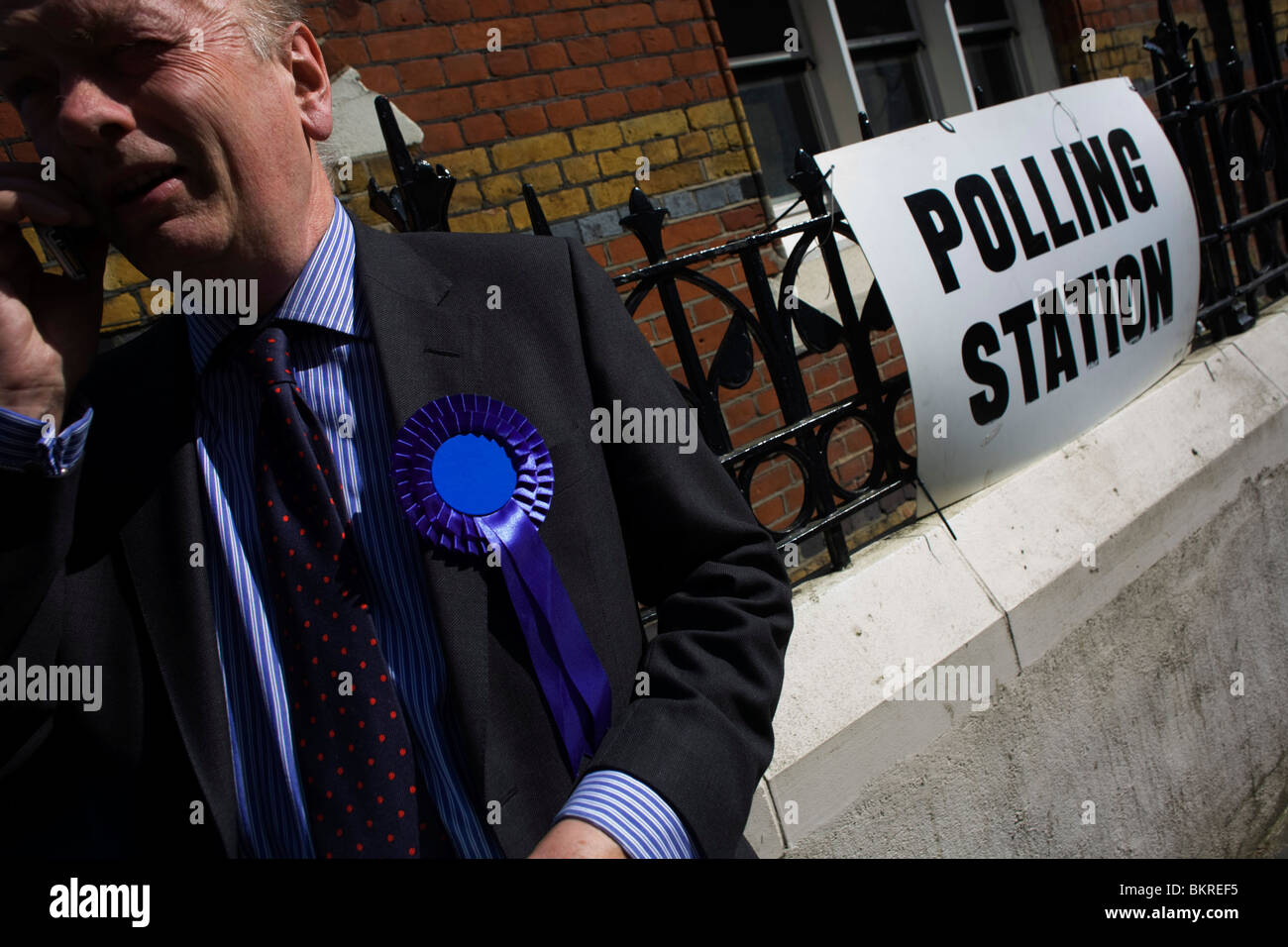 A Conservative Party teller takes a call outside temporary polling ...