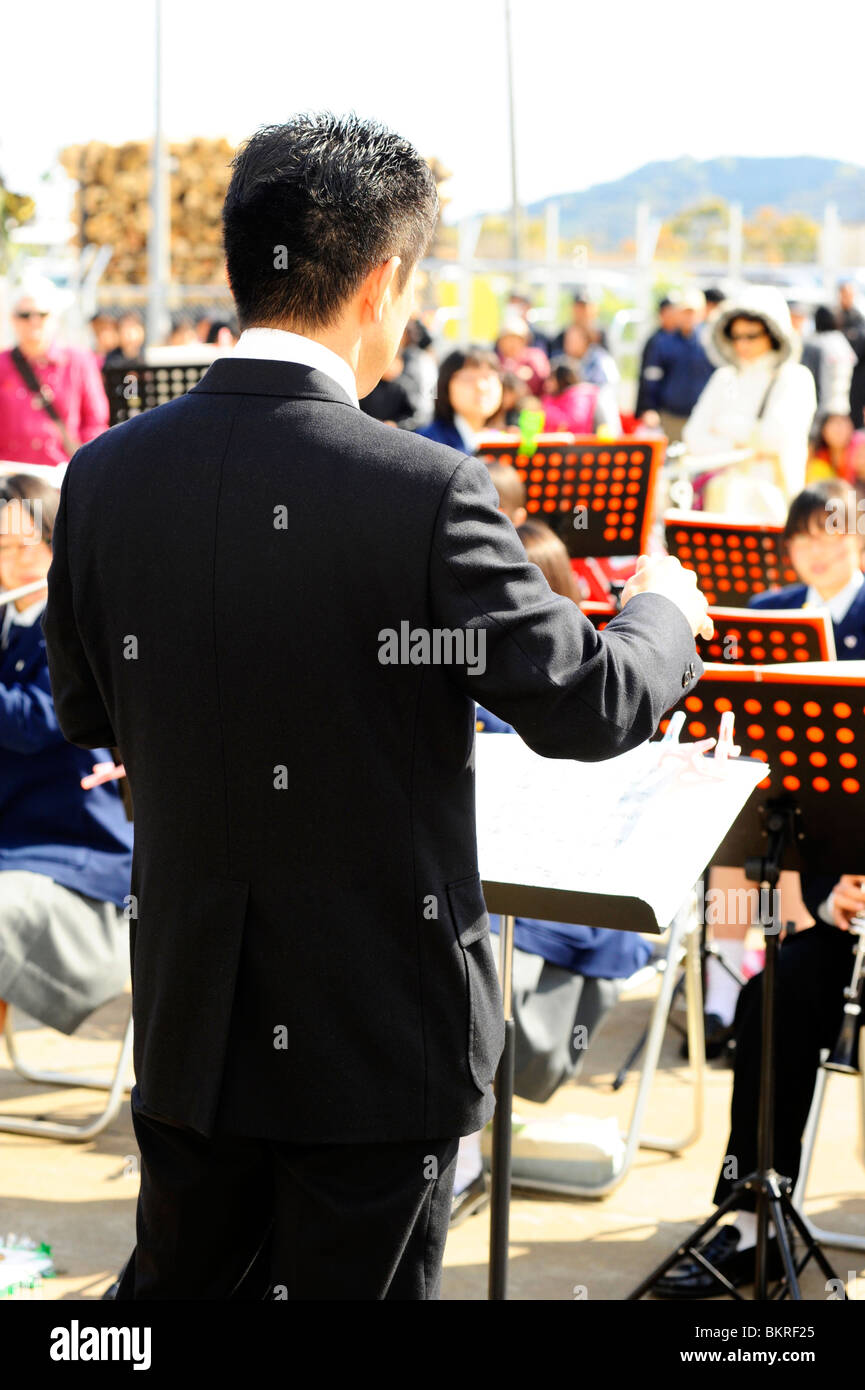 Conductor conducting school orchestra in Hyuga Japan Stock Photo - Alamy