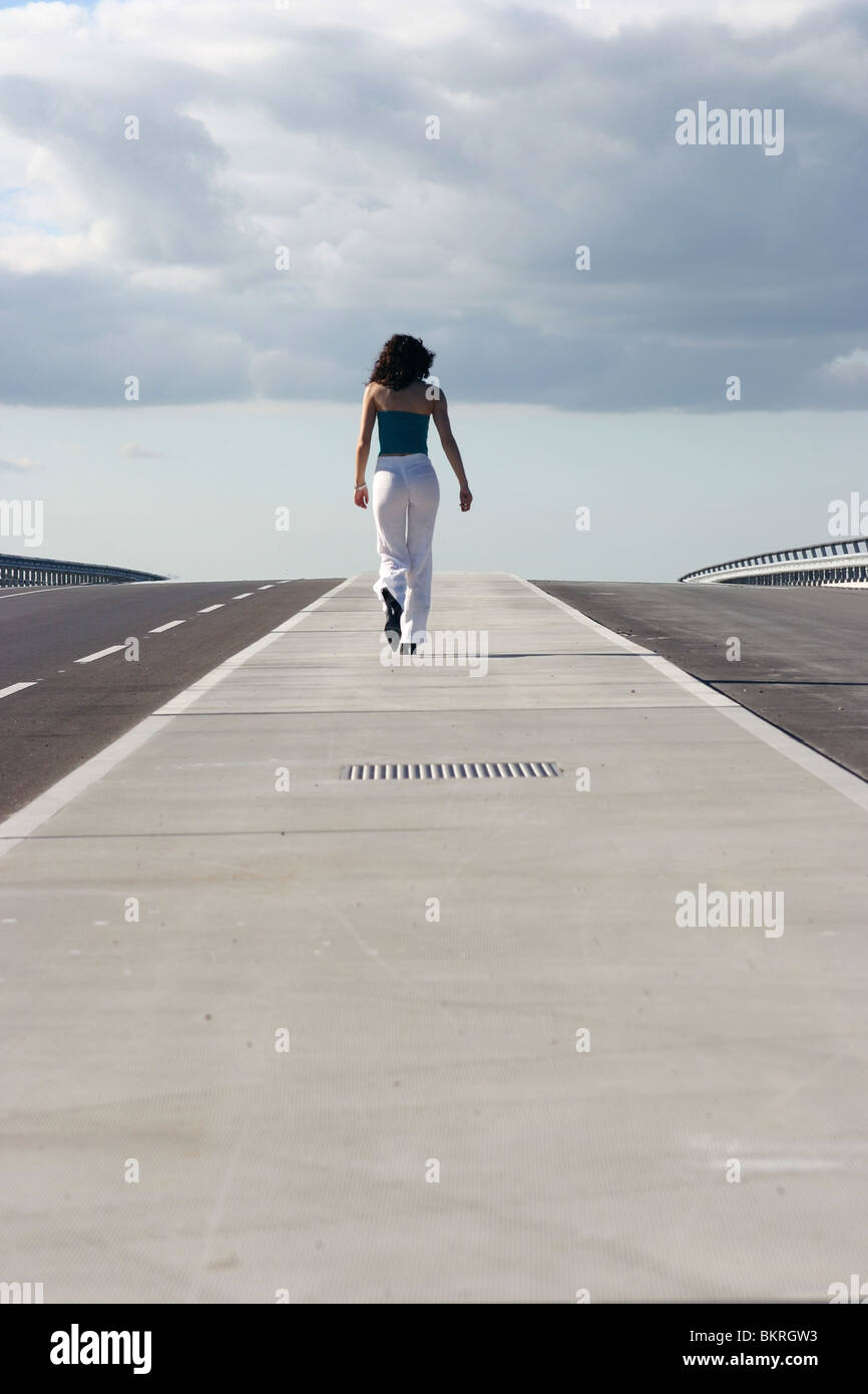 Woman rear view walking empty street hi-res stock photography and ...