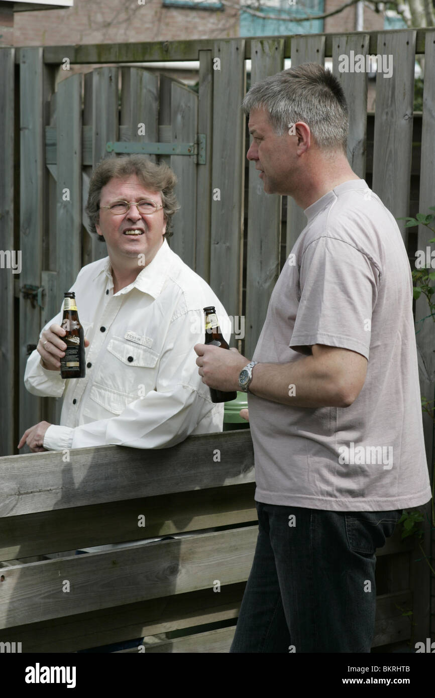 Two men talking over fence hi-res stock photography and images - Alamy