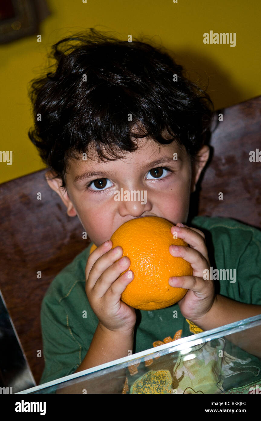 A young boy smells an Orange Stock Photo - Alamy