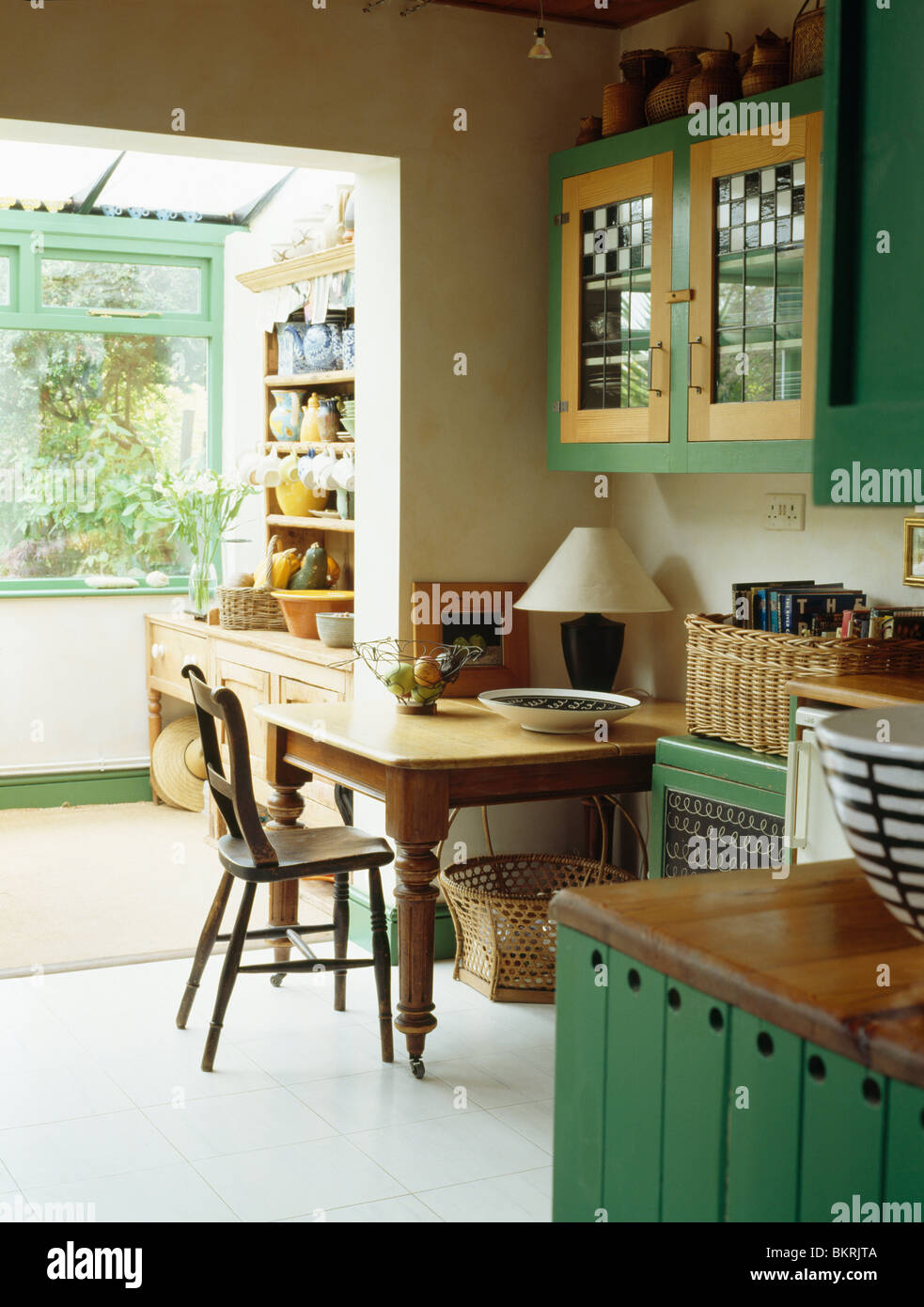 Wooden table and chairs in traditional country kitchen with fitted ...