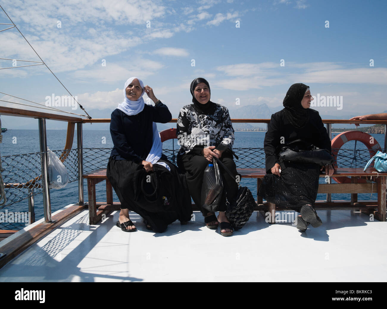 Turkish muslim women in traditional moderate dress with headscarves ...
