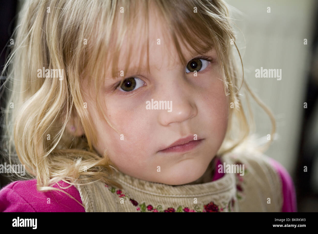 Caucasian girl innocent child serious Sad face Stock Photo - Alamy