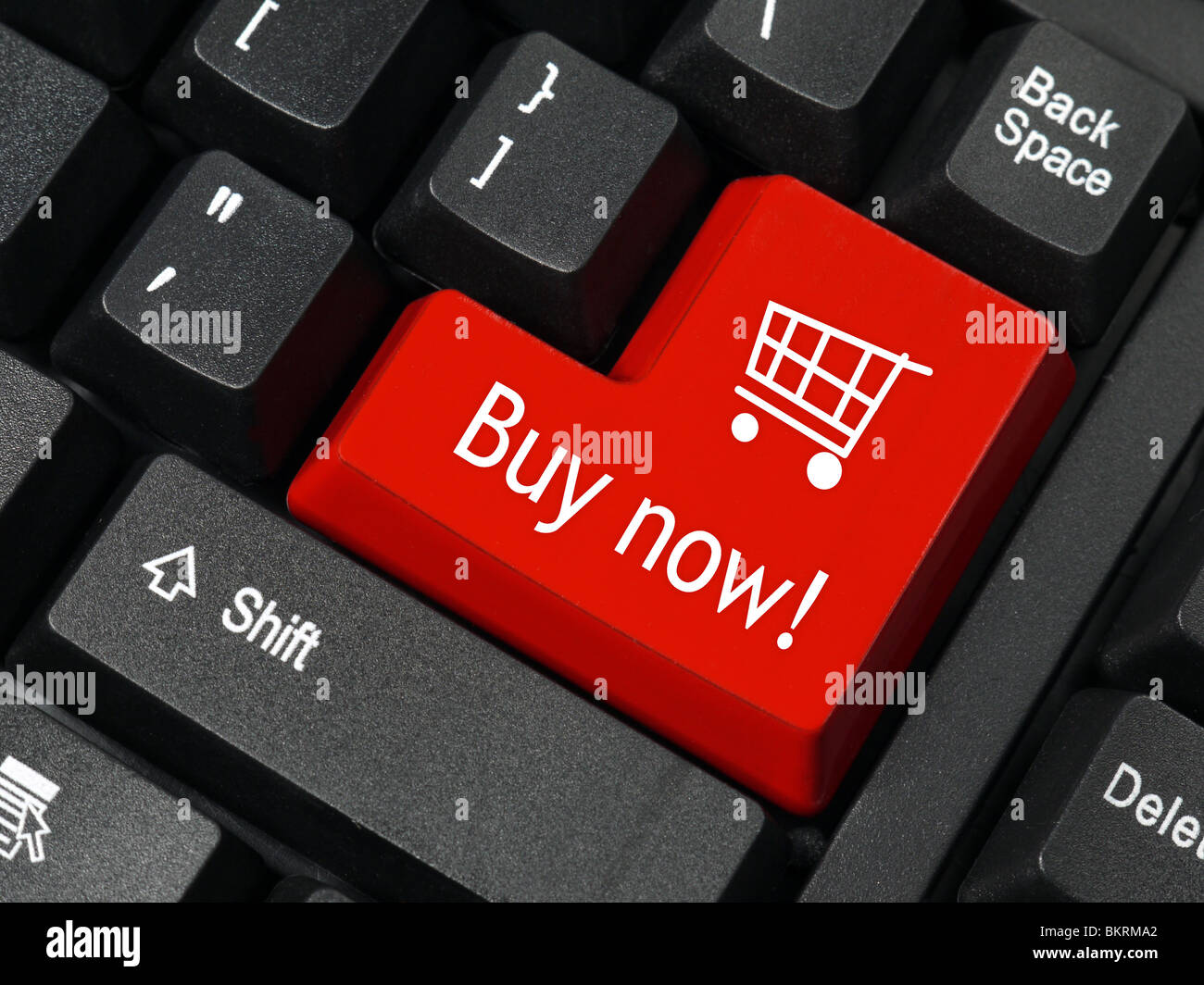 Closeup of red computer keyboard key with shopping cart symbol and Buy ...