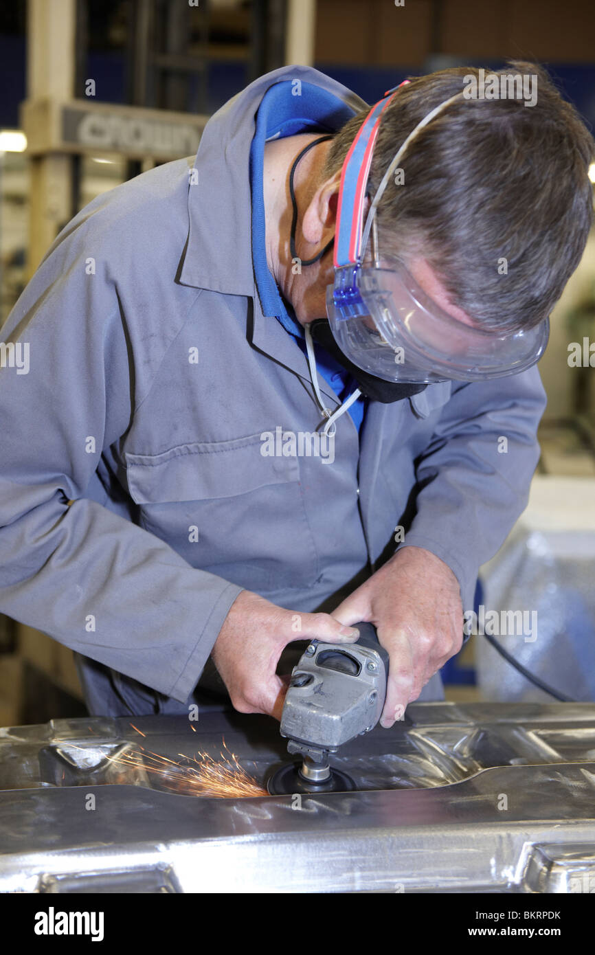 factory floor worker using a angle grinder on metal surface Stock Photo ...