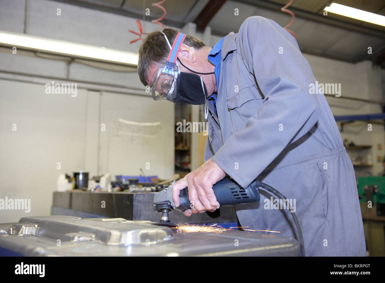 factory floor worker using a angle grinder on metal surface Stock Photo ...