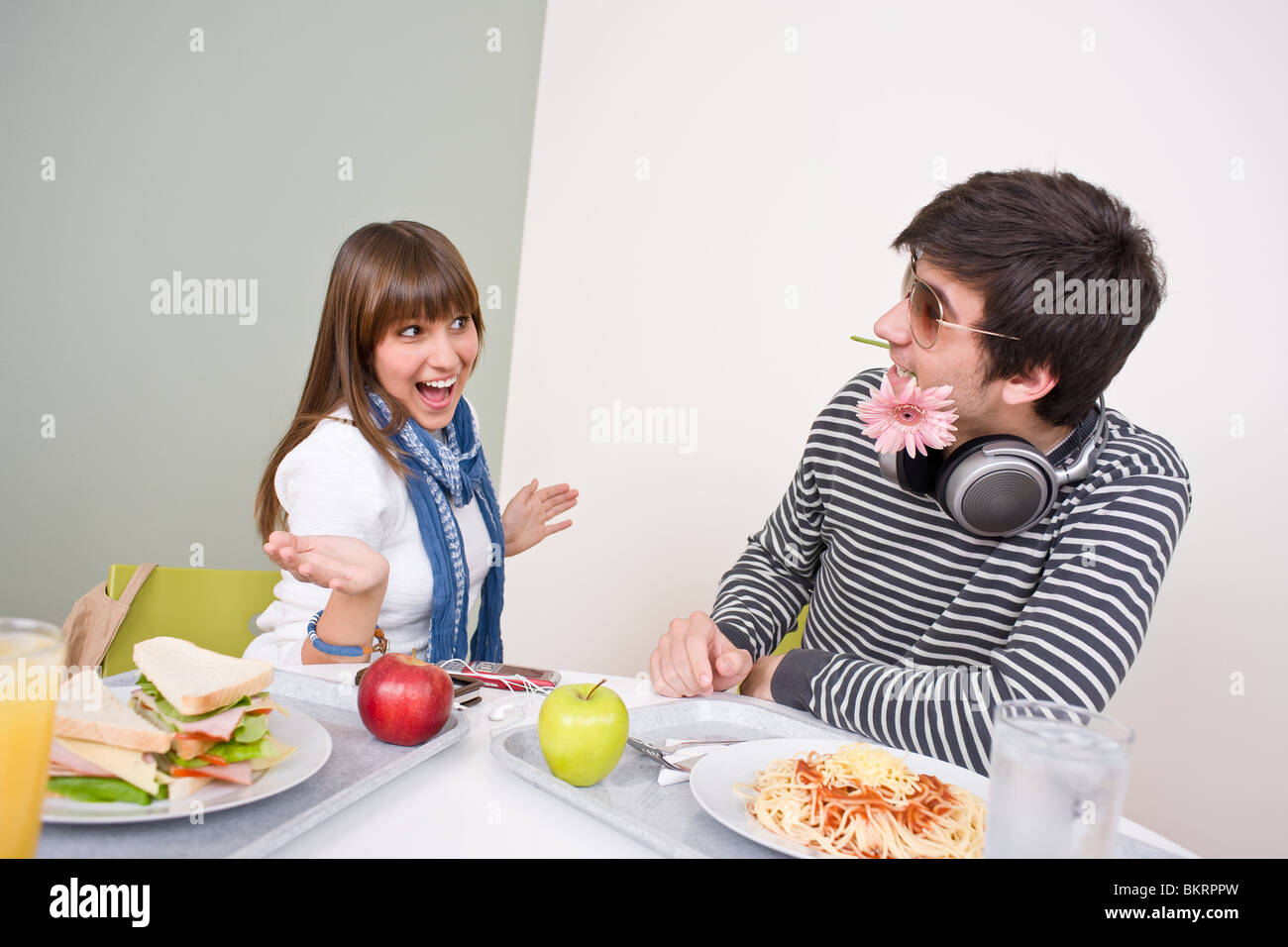Student cafeteria - teenage couple having fun during lunch break Stock ...