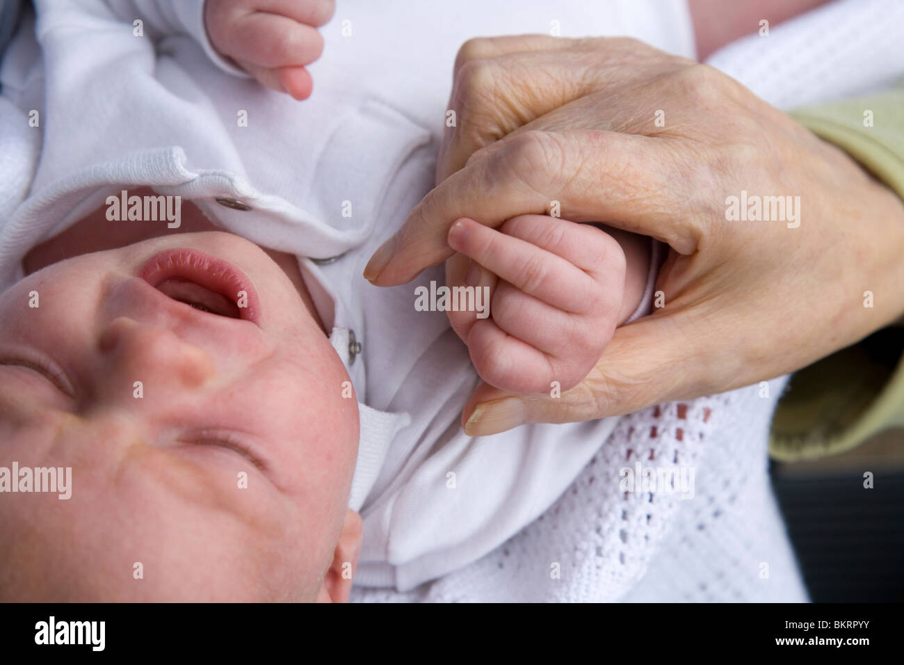 Older woman holding newborn baby hi-res stock photography and images ...